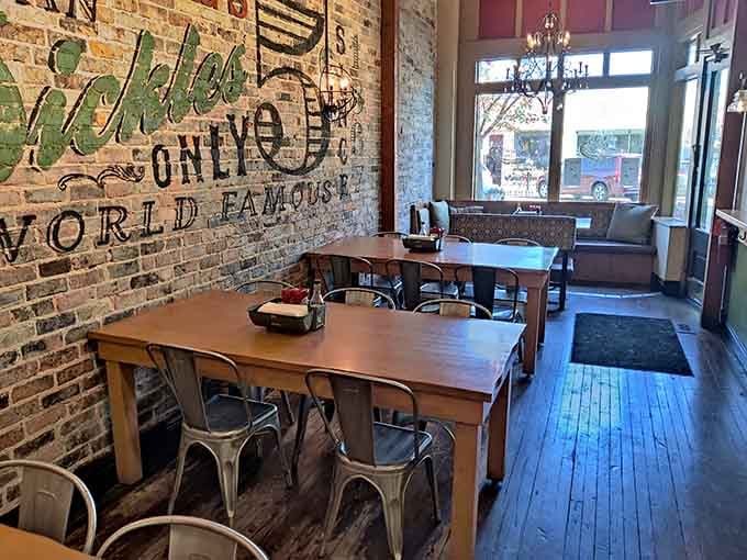 Exposed brick declaring pickle supremacy while you enjoy your sandwich feels exactly right in every possible way.