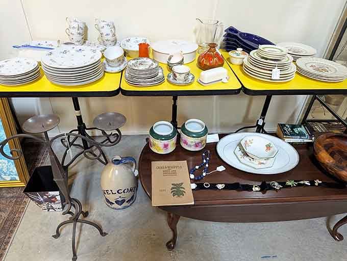 Stacked china sets and ceramic crocks lined up neatly, someone's Sunday dinner tradition is waiting for a new family.