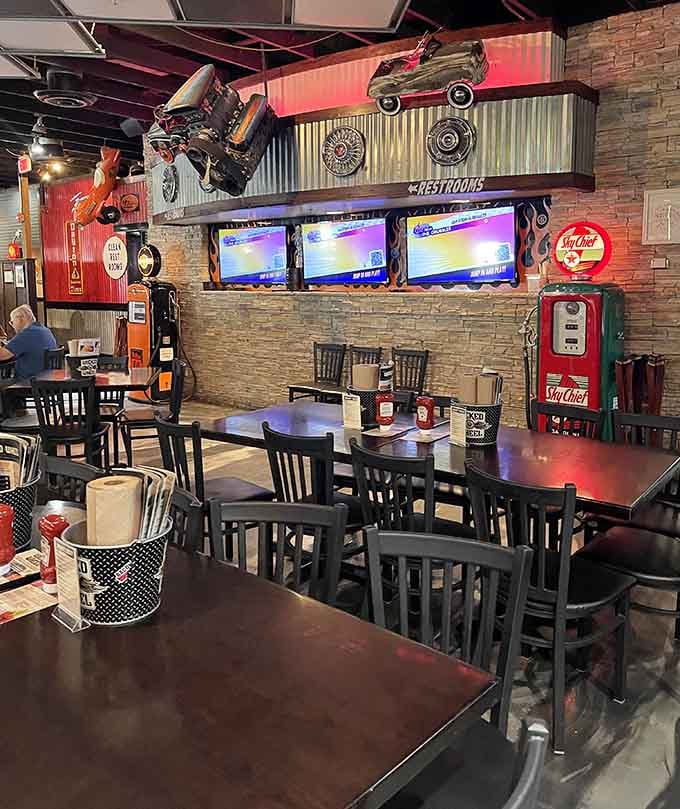 Vintage gas pumps, actual car parts mounted on the wall, and TVs everywhere, this dining room tells a story worth reading.