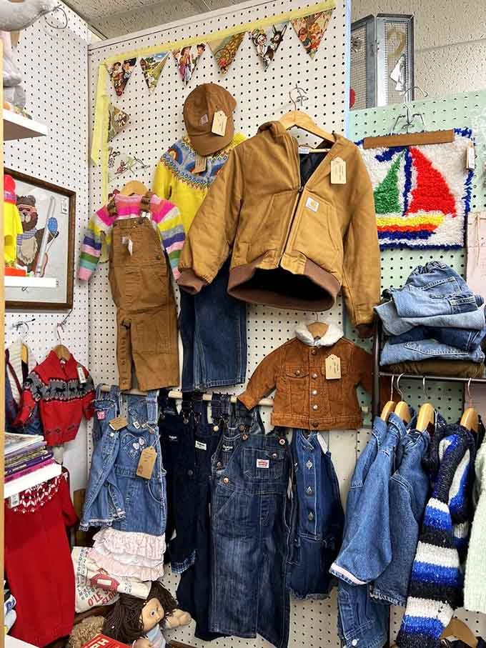 Carhartt jackets and denim overalls hanging like they're ready for another few decades of hard work.
