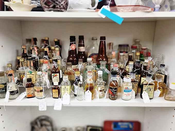 Rows of miniature vintage bottles lined up like tiny ambassadors from decades of American drinking history.