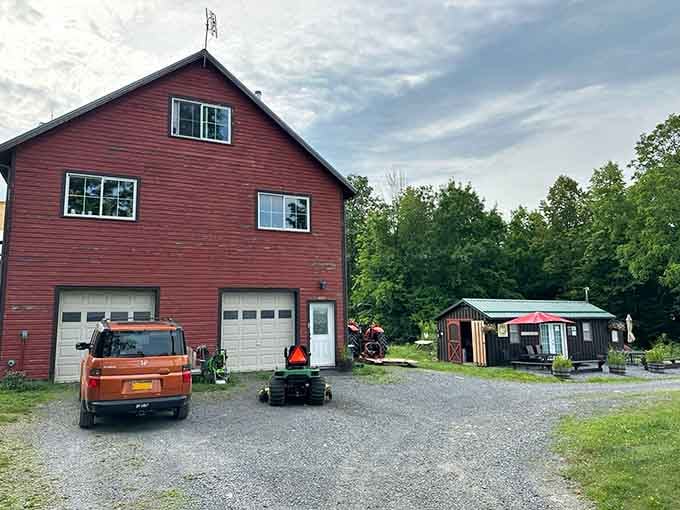 A big red barn, a John Deere mower parked out front, and a little roadside stand that promises something genuinely good is happening here.
