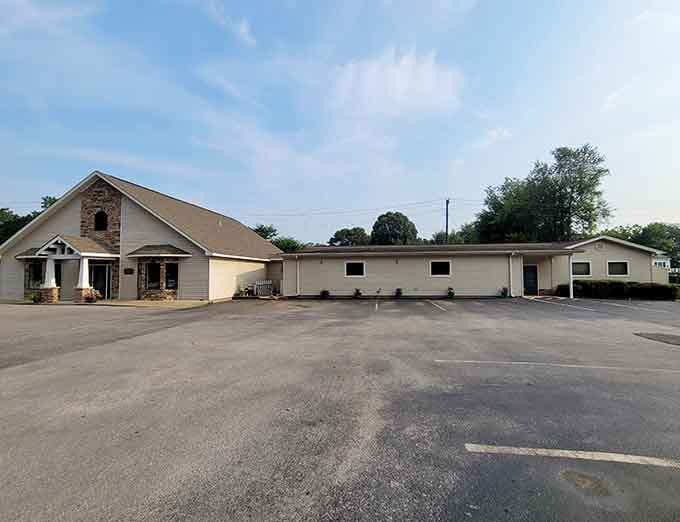 Stone facade, tidy landscaping, and a parking lot that says your afternoon of relaxation starts the moment you arrive.