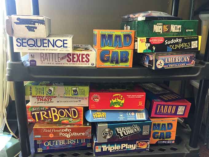 Apples to Apples, Taboo, Trivial Pursuit, and a dozen more classics stacked up, ready for the best game night of the year.