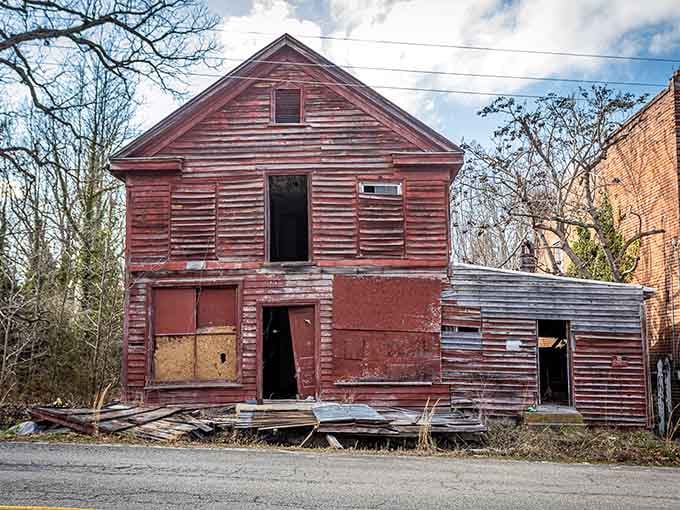The old dance hall's weathered red siding once echoed with music; now it echoes with nothing at all.