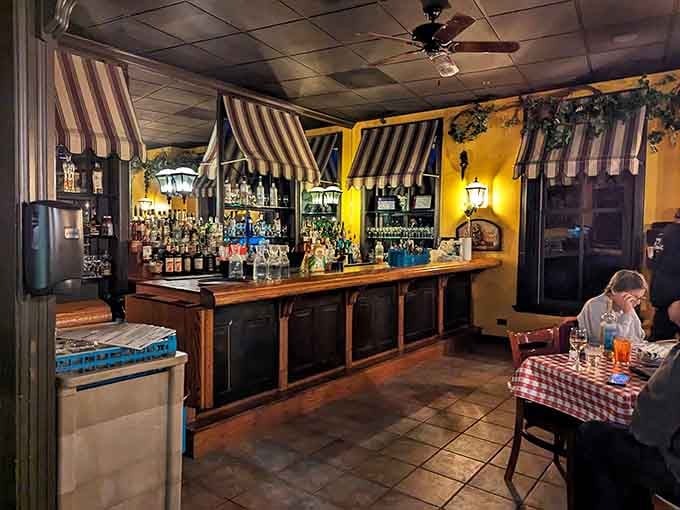 The bar area features striped awnings and warm lighting that invite you to settle in awhile.
