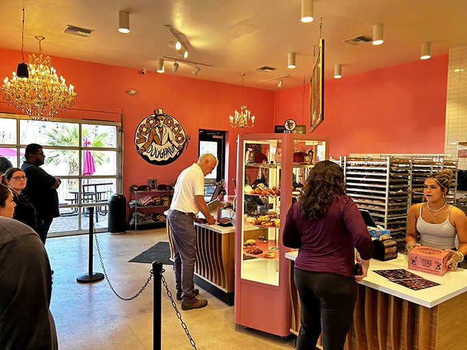 Customers line up under those chandeliers, eyes wide, ready to make some tough donut decisions.