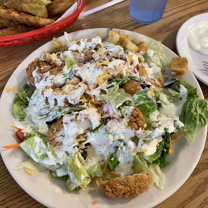 A large dinner salad topped with golden fried chicken and ranch dressing. Even the salad here means serious business.