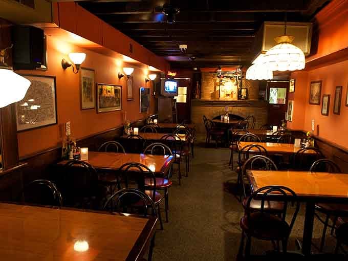 Framed artwork on warm orange walls, candles on the tables, and that golden glow, Wag's dining room feels like a welcome exhale.