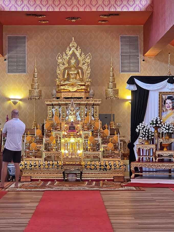 A glowing golden Buddha altar commands the entire room &mdash; serene, magnificent, and completely unforgettable in every way.