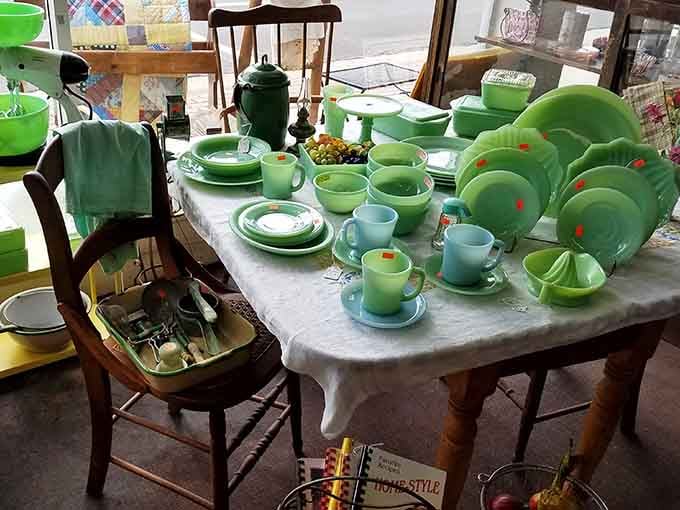 A full set of jade green Jadeite kitchenware glowing in the window, cheerful enough to make any kitchen jealous.