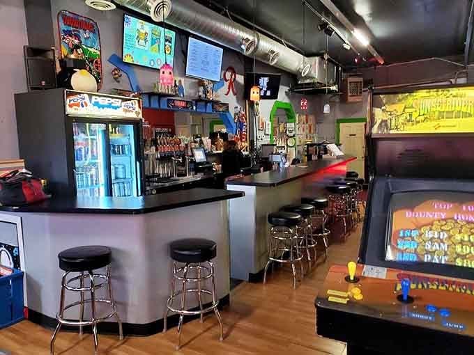 The bar at 8-Bit Arcade is cheerful, stocked, and decorated with enough gaming art to smile at.