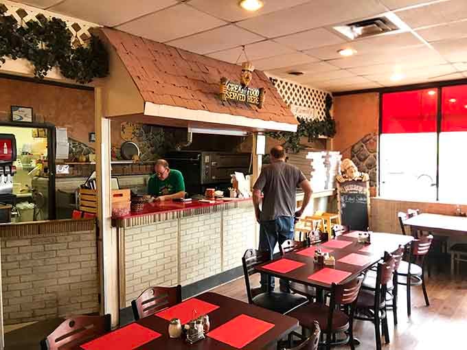 Behind that counter, real pizza magic happens daily. The sign says "Great Food Served Here," and it's not bluffing.