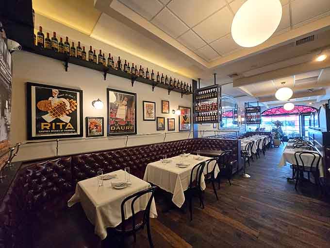 Vintage French posters on white walls above those leather banquettes transport diners across the Atlantic without leaving their seats.