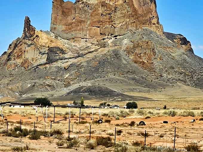 Life continues at the base of giants, where homes and livestock share space with geological wonders.