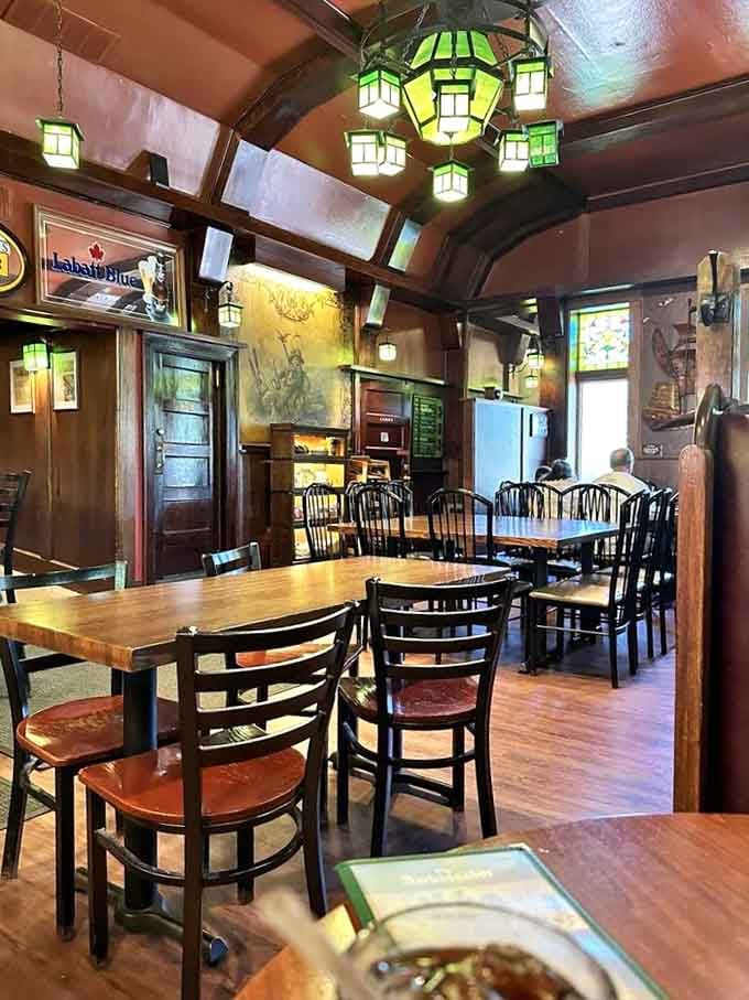 Wooden tables and classic chairs arranged under that stunning ceiling, where countless conversations have unfolded over good meals.