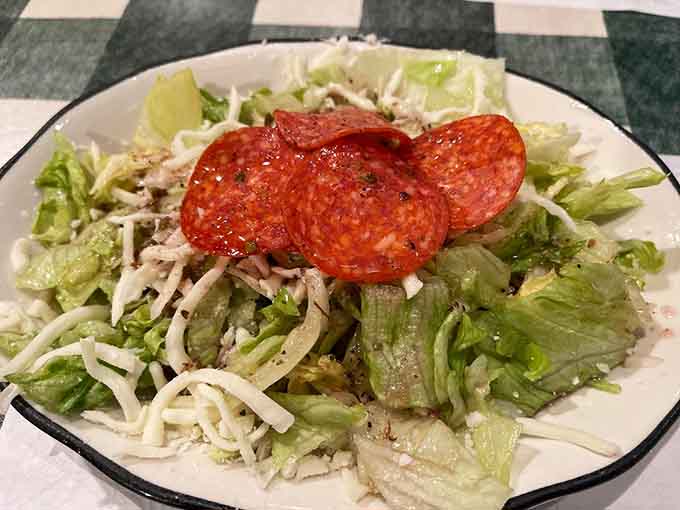 A crisp salad topped with pepperoni slices, because at Amici's even the salad knows it's at an Italian restaurant.