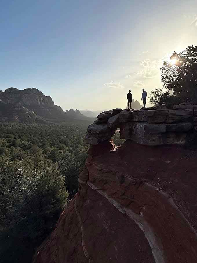 Two silhouettes on a canyon ledge at golden hour. This is the photo your phone's camera roll deserves.