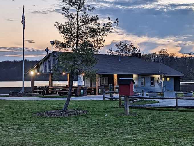 The park's boathouse and pavilion at dusk, glowing warmly like it's always happy to see you.