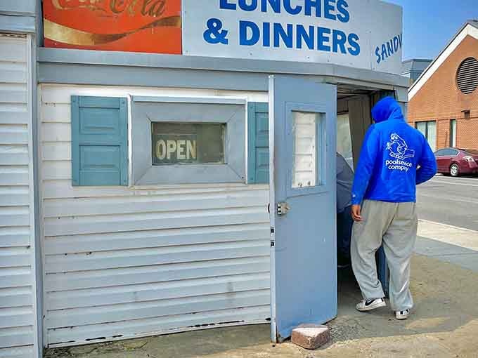 That "OPEN" sign in the window is basically the best news you'll read all day. Someone in a blue hoodie already figured that out.