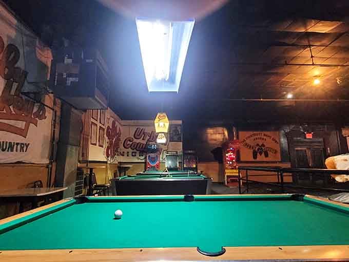 Green felt pool tables under bright skylights offer a surprisingly normal activity in decidedly abnormal surroundings.