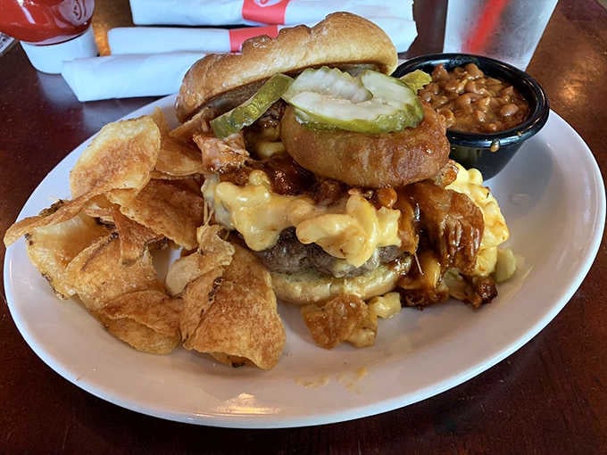 Mac and cheese spilling out of a burger bun is the kind of chaos everyone secretly wants.