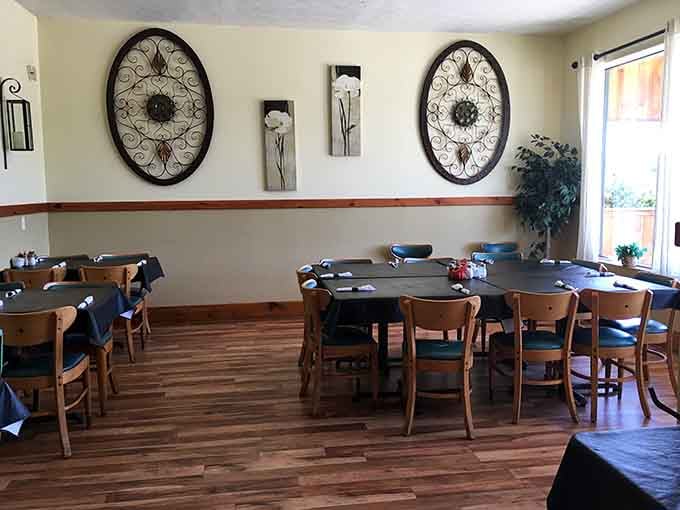 Oval wall art, wood floors, and natural light pouring in, this dining room feels like someone actually thought about your comfort.