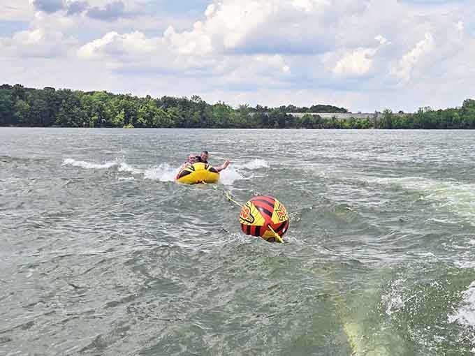 Tubing behind a boat on Caesar Creek Lake, where dignity is optional and laughter is absolutely guaranteed.