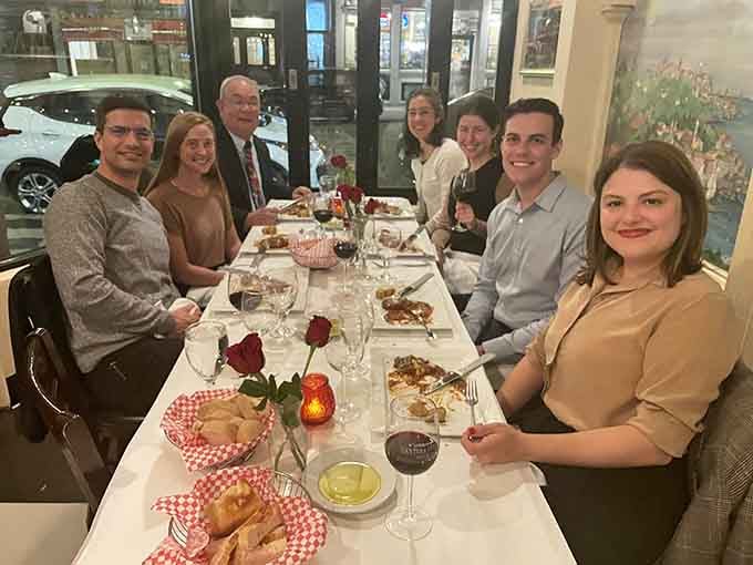 Three generations around one table, red roses between the glasses, bread in the basket, and smiles all around. This is exactly what dinner is for.
