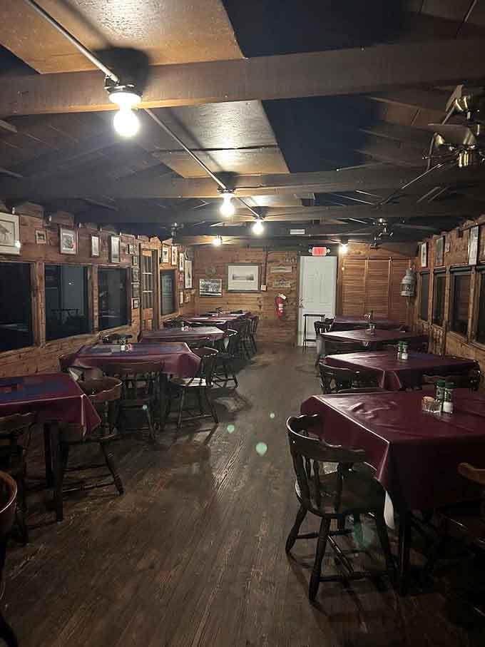 Burgundy tablecloths, wooden floors, and soft overhead lights, this dining room sets the mood without even trying.