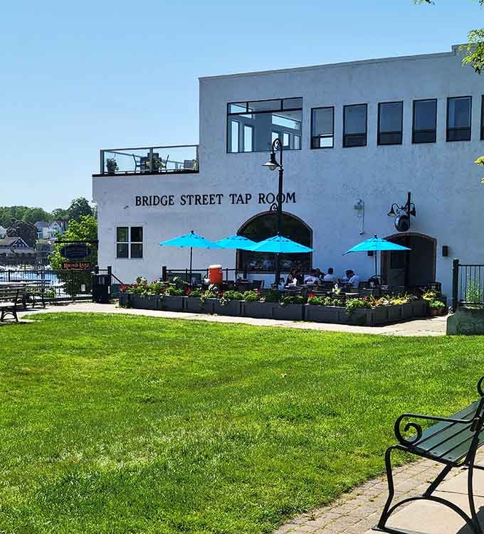 Bridge Street Tap Room offers cold beverages and channel views where watching boats becomes your new favorite spectator sport.