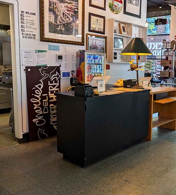The order counter at Charlie's, framed awards, a gallery wall, and a yellow rotary phone, because why not.