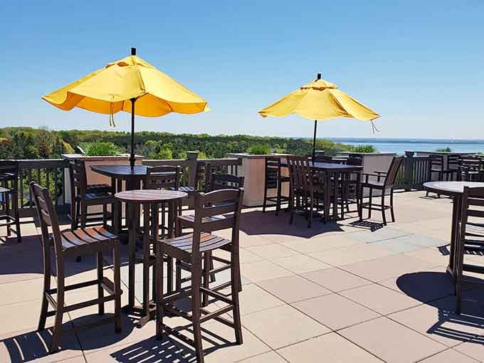 Bright yellow umbrellas, open sky, and Grand Traverse Bay in the distance, this terrace is doing absolutely everything right.