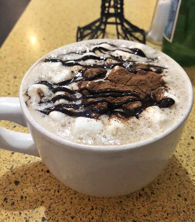 Chocolate drizzle, cocoa powder, and steamed foam in a generous mug &mdash; this hot chocolate means you're not going anywhere for a while.
