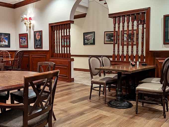 Rich woodwork, framed horse racing prints, and turned spindle dividers. This cozy corner feels like Kentucky history pulled up a chair.