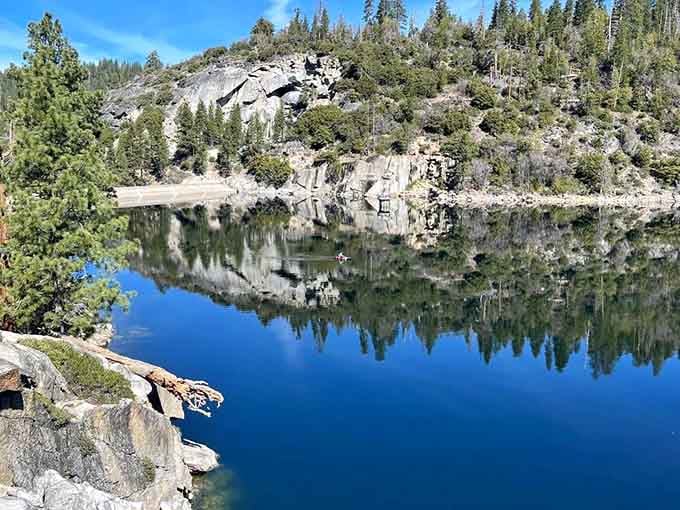 The still water reflects surrounding cliffs like a mirror, creating that perfect Instagram moment everyone's chasing these days.