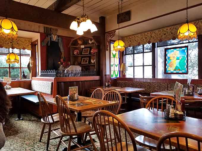 Stained glass windows, wooden chairs, and vintage charm, this dining room feels like stepping into a very well-fed memory.