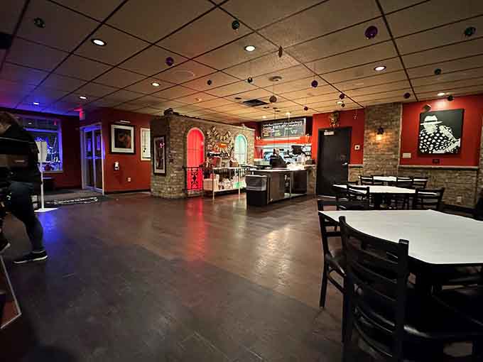 The open floor, deep red walls, and warm lighting make this room feel like a celebration waiting to happen.