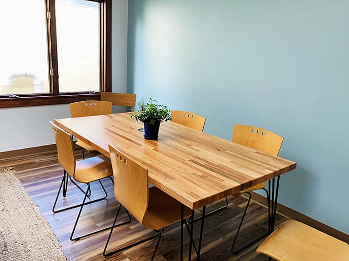 Hairpin legs, butcher block top, and a plant that looks genuinely happy to be there. Good taste lives in the details.