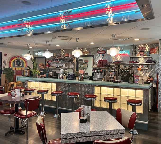 That glowing counter with chrome stools is the kind of setup that makes you want to linger over coffee.