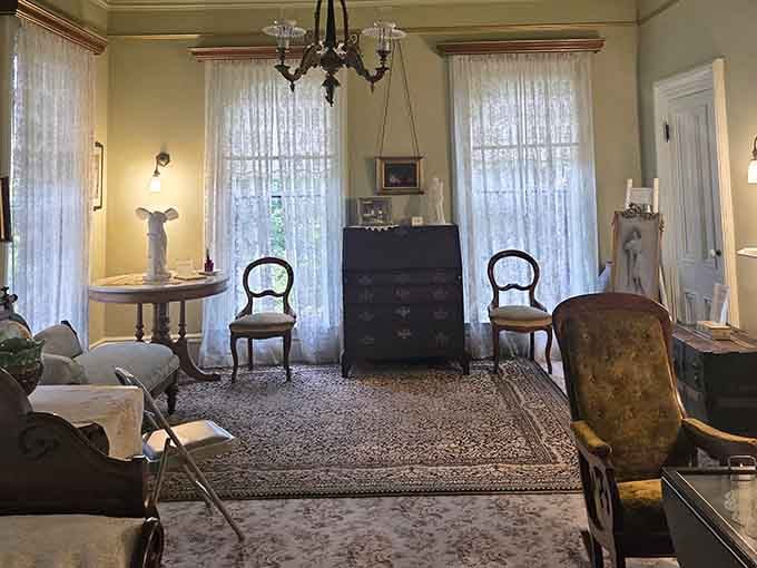 Lace curtains, period furniture, and afternoon light pouring in. This parlor hasn't lost a single step.