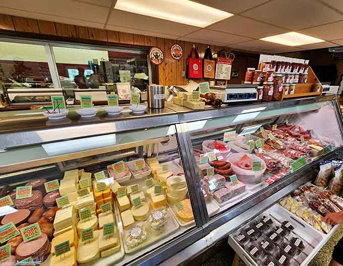 Cheese wedges and cured meats sharing a case together, which is honestly the most harmonious relationship imaginable.