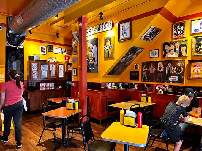 Bright yellow walls, rock and roll artwork, and hot dogs, this room has excellent taste in everything.