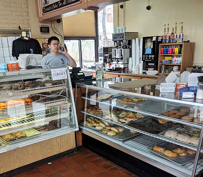 Display cases loaded with donuts, pastries, and baked goods. Dom Bakeries doesn't believe in empty shelves.