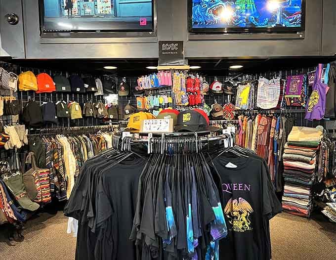 Band tees, hats, and colorful gear fill this corner. Queen, AC/DC, and more, your wardrobe has been waiting for this moment.
