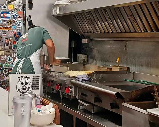 Steam rising off the flat-top, hashbrowns sizzling in the corner, the Durango Diner skull sign watching over it all approvingly.
