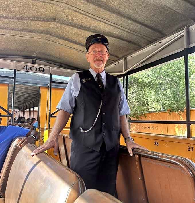 A conductor in full uniform is the kind of detail that tells you this railroad takes pride seriously.