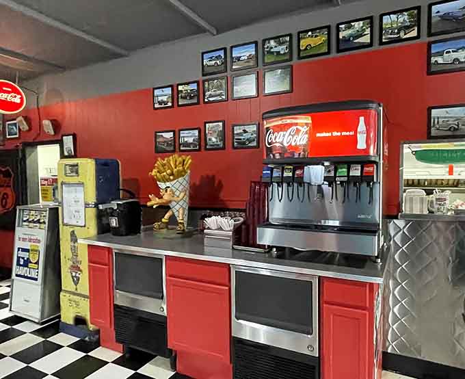 A vintage-style Coca-Cola dispenser and framed car photos &mdash; even the beverage station has something worth looking at.