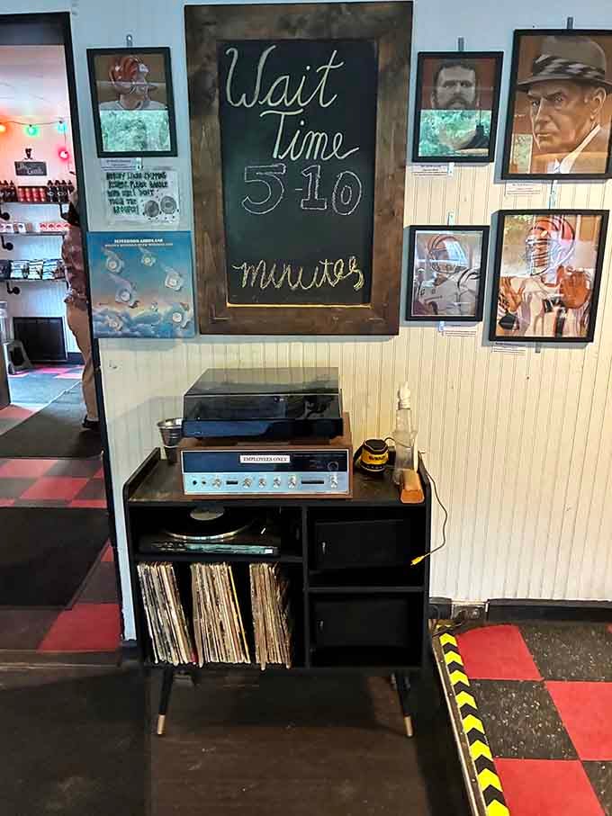 A vintage turntable, stacked vinyl records, and a chalkboard showing a five-to-ten minute wait, honestly, that's not nearly long enough.