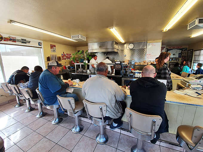 Counter seats full, cook working the grill, conversations flowing. This is what a real diner looks like.